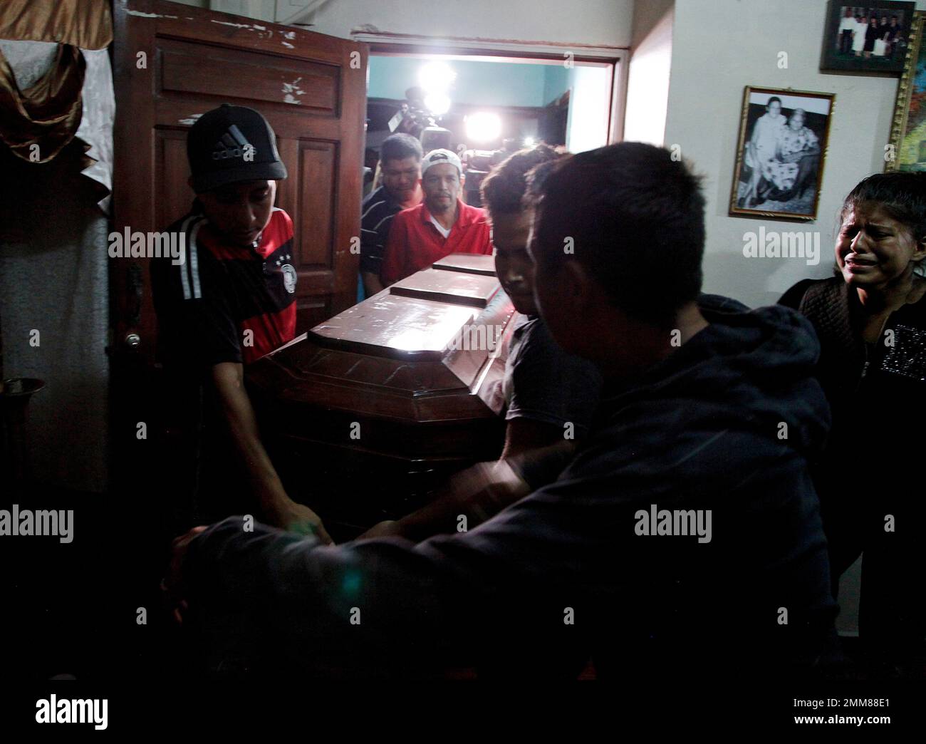 Relatives and friends of migrant Henry Adalid Diaz Reyes carry his ...