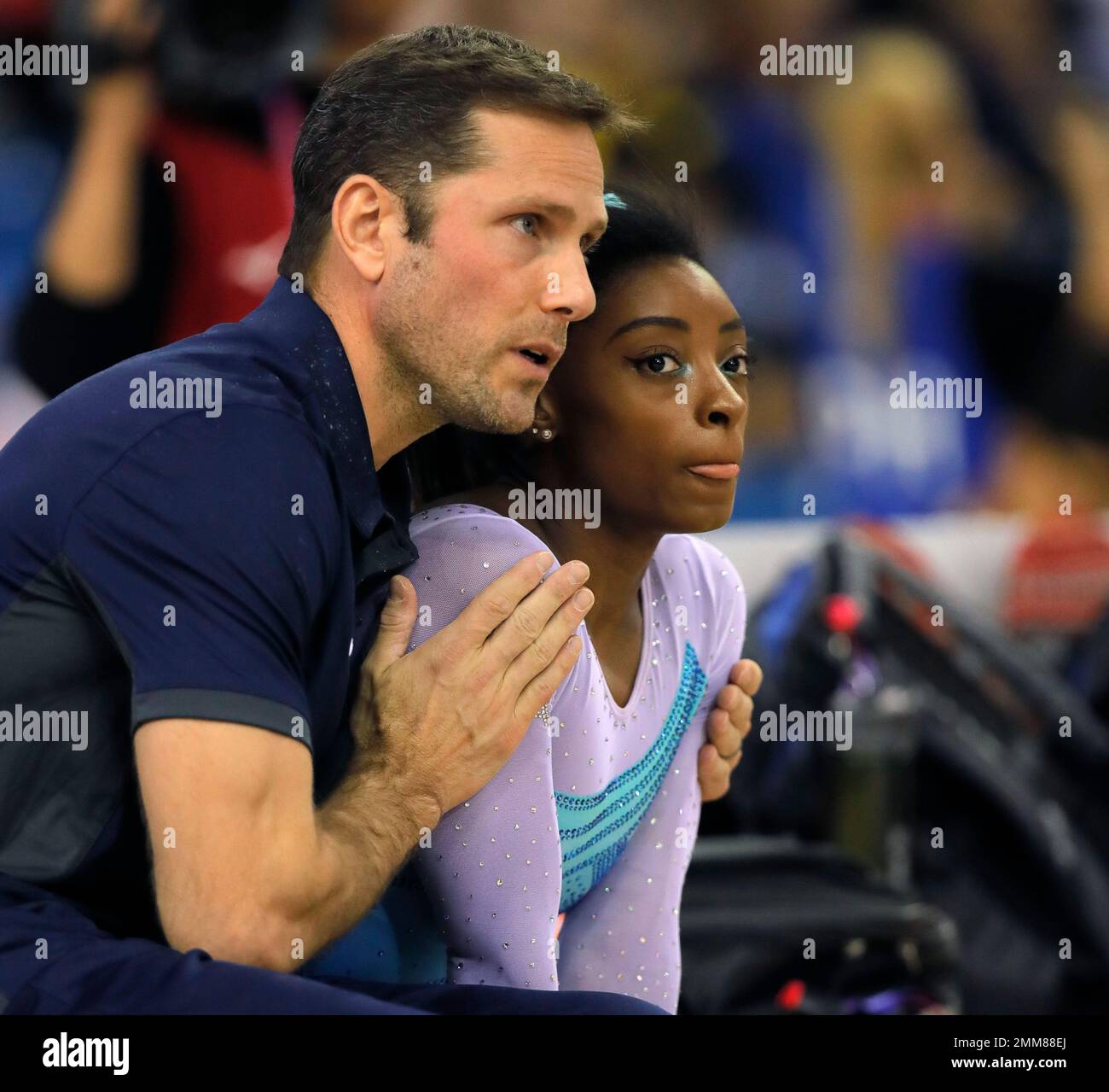 Simone Biles of the U.S. is hugged by her coach Laurent Landi during ...