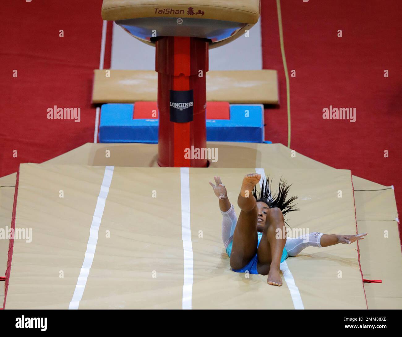 Simone Biles of the U.S. misses her landing after her jump on the vault ...