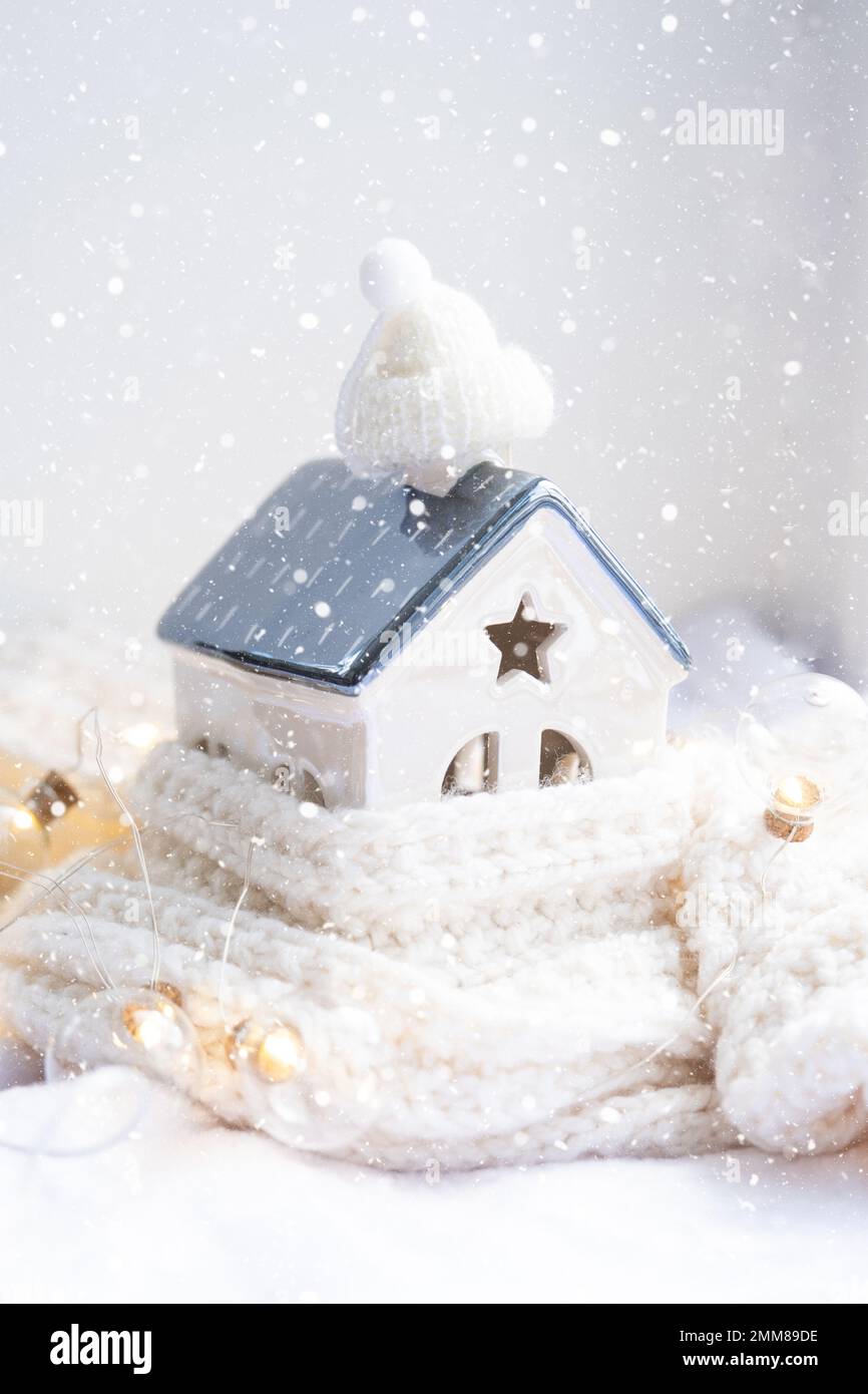 Cozy house is wrapped in a hat and scarf in a snowstorm -window sill ...