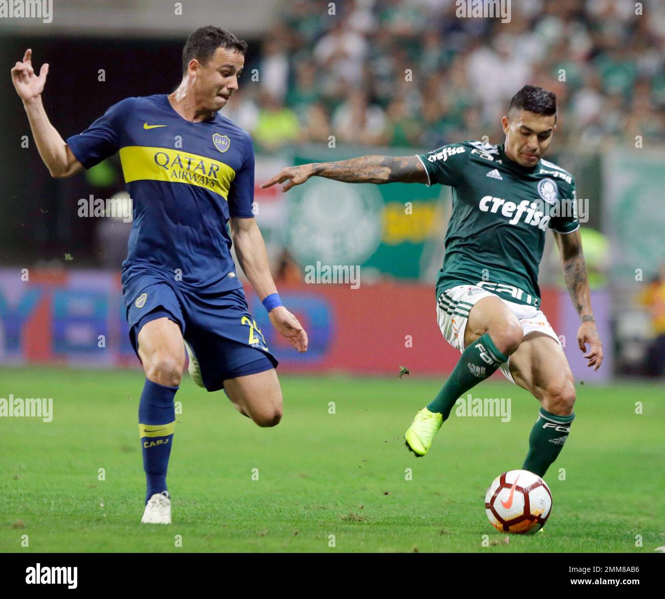 Leonardo Jara of Argentina's Boca Juniors, left, fights for the ball ...