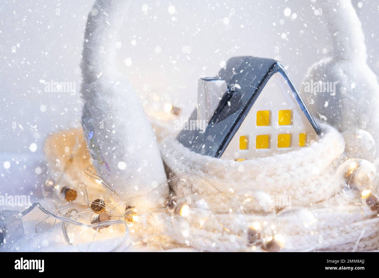 Cozy house is wrapped in a hat and scarf in a snowstorm -window sill ...