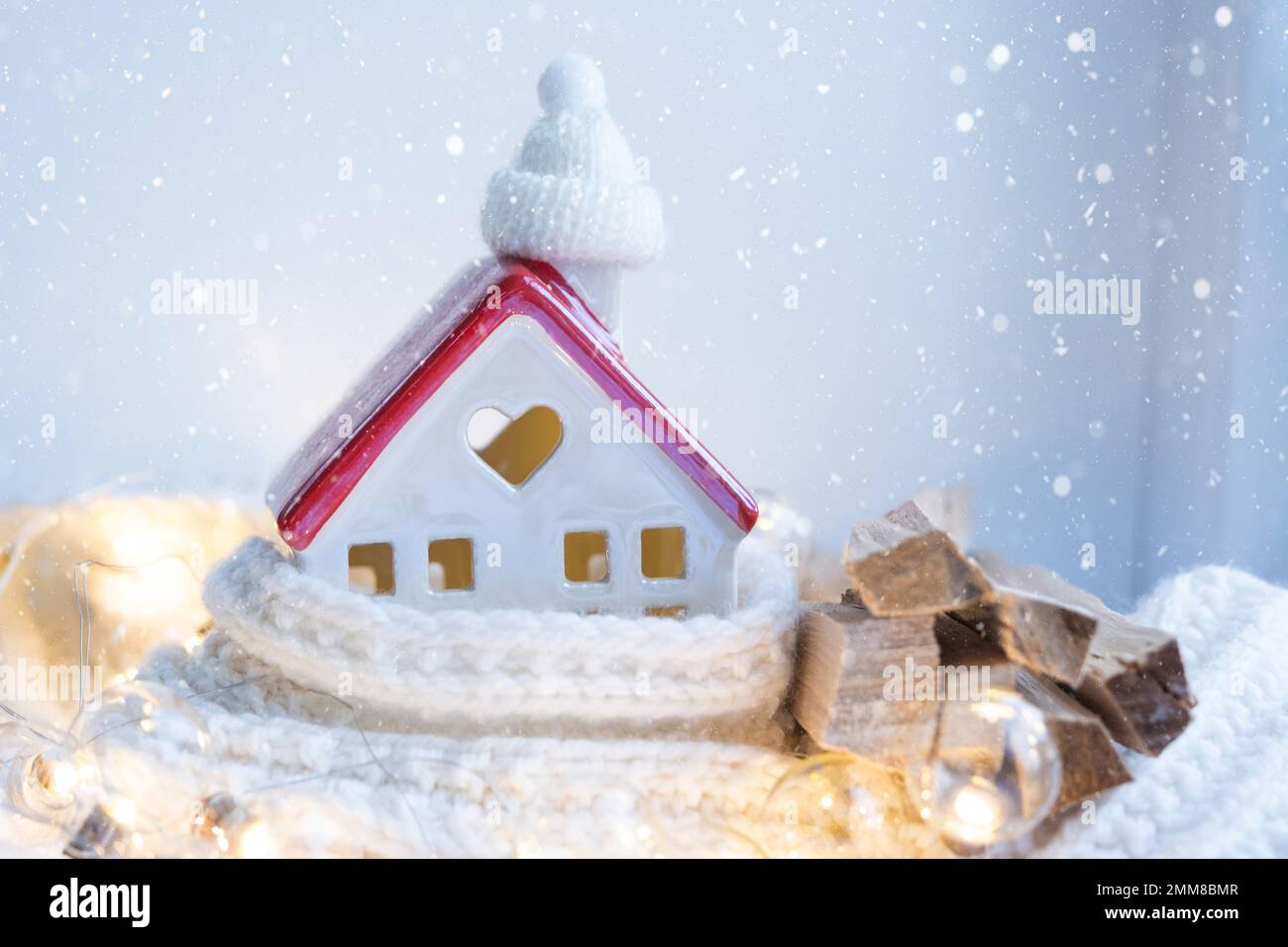 Cozy house is wrapped in a hat and scarf in a snowstorm -window sill ...