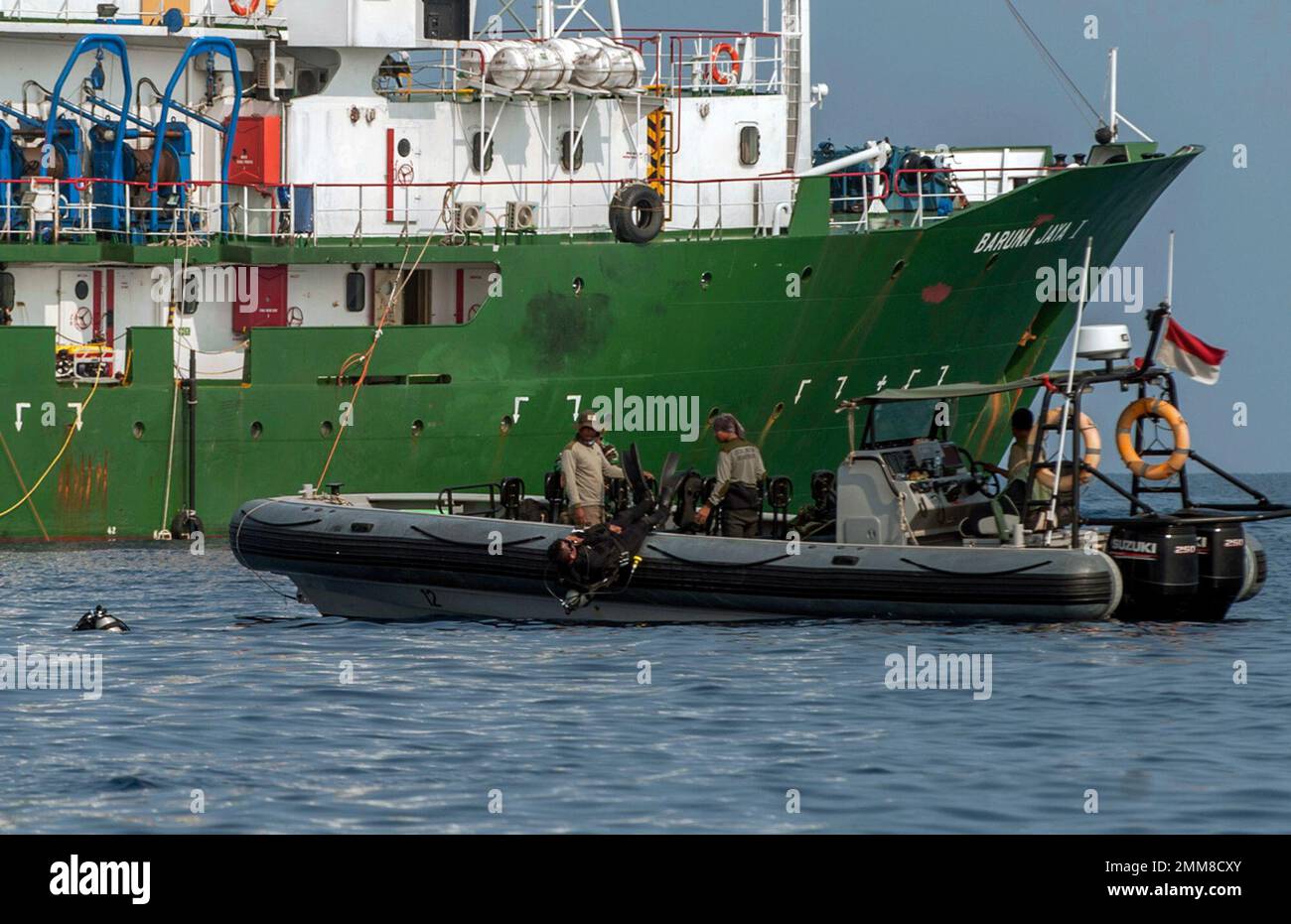 An Indonesian Navy frogman makes an entry into the water during a ...