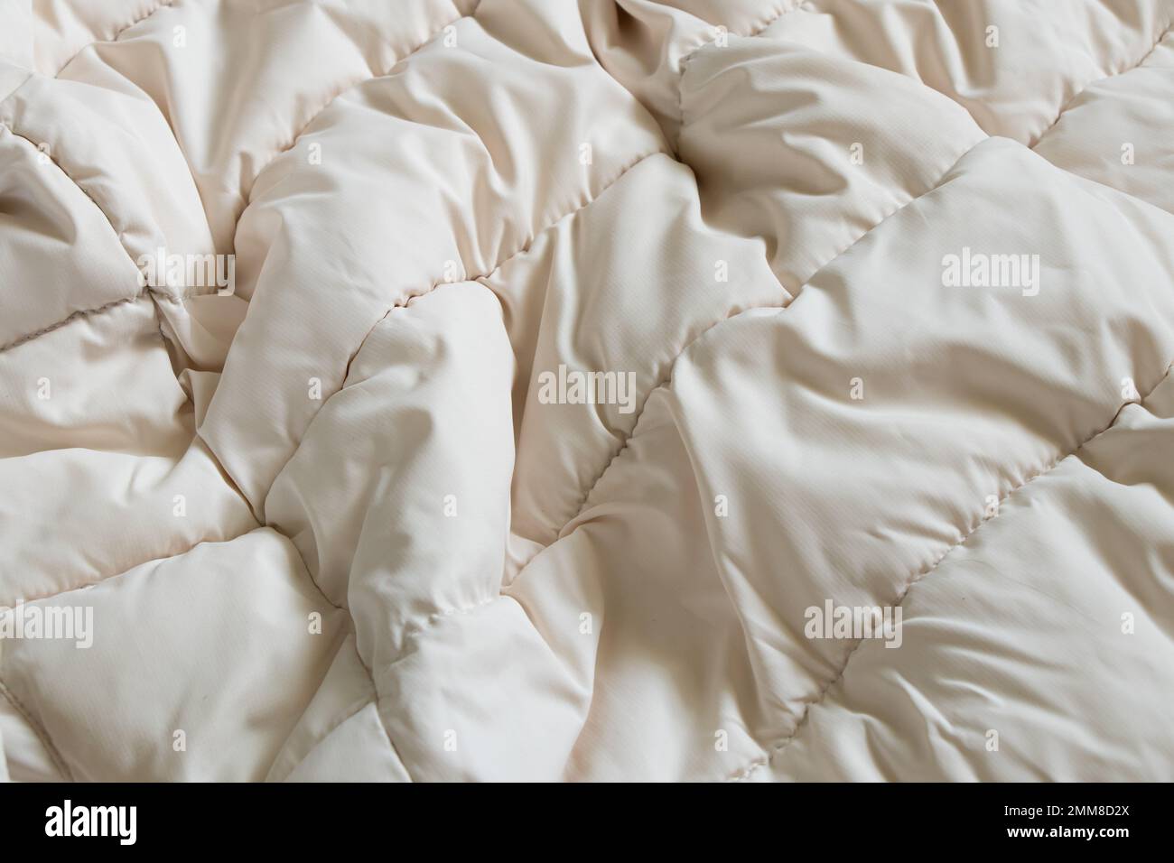 women's padded white soft jacket as background, background of soft ...