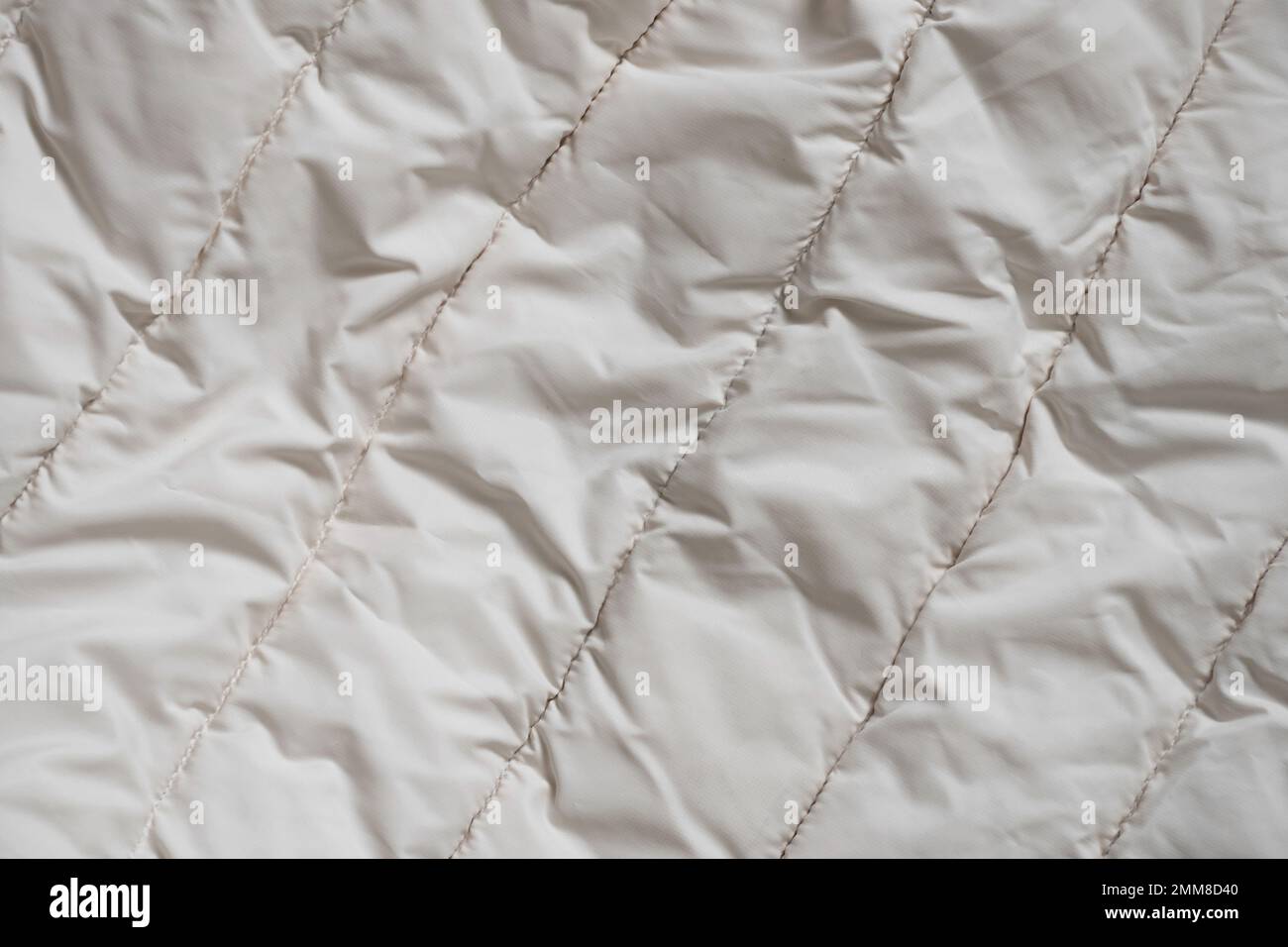 women's padded white soft jacket as background, background of soft ...