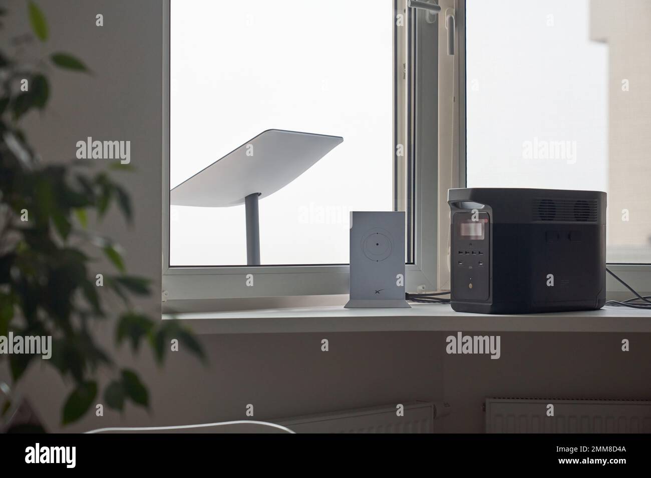 KYIV, UKRAINE - JANUARY 24, 2023: Starlink antenna behind window, wi-fi ...