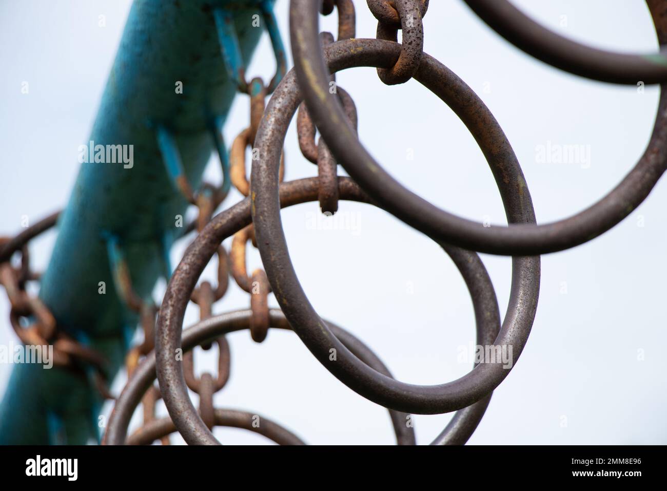 old rusty rings on a chain on a horizontal bar for gymnastics on the ...