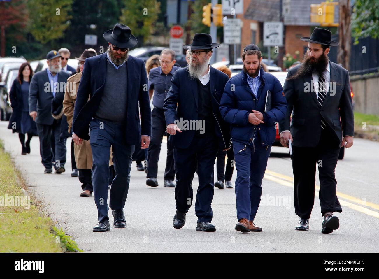 Mourners walk behind the hearse carrying the casket of Dr. Jerry ...