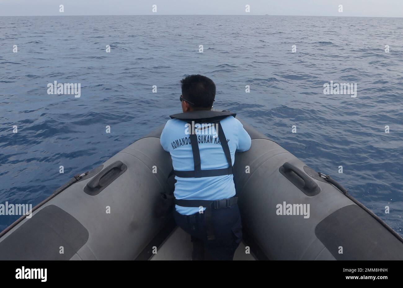 An Indonesian Navy frogman scans the horizon during a search operation ...