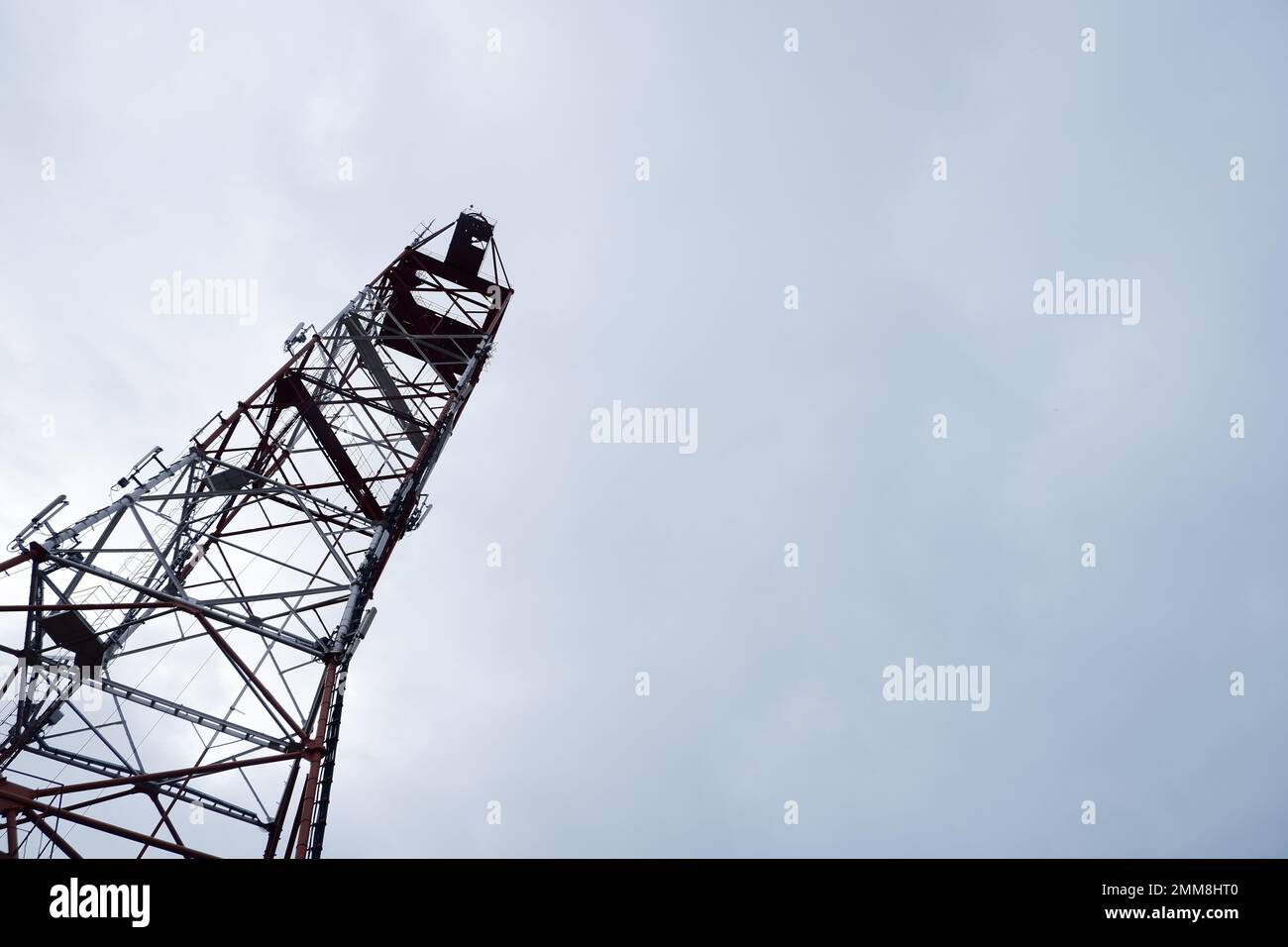 An old television and radio tower in faded colors looks vertically at ...