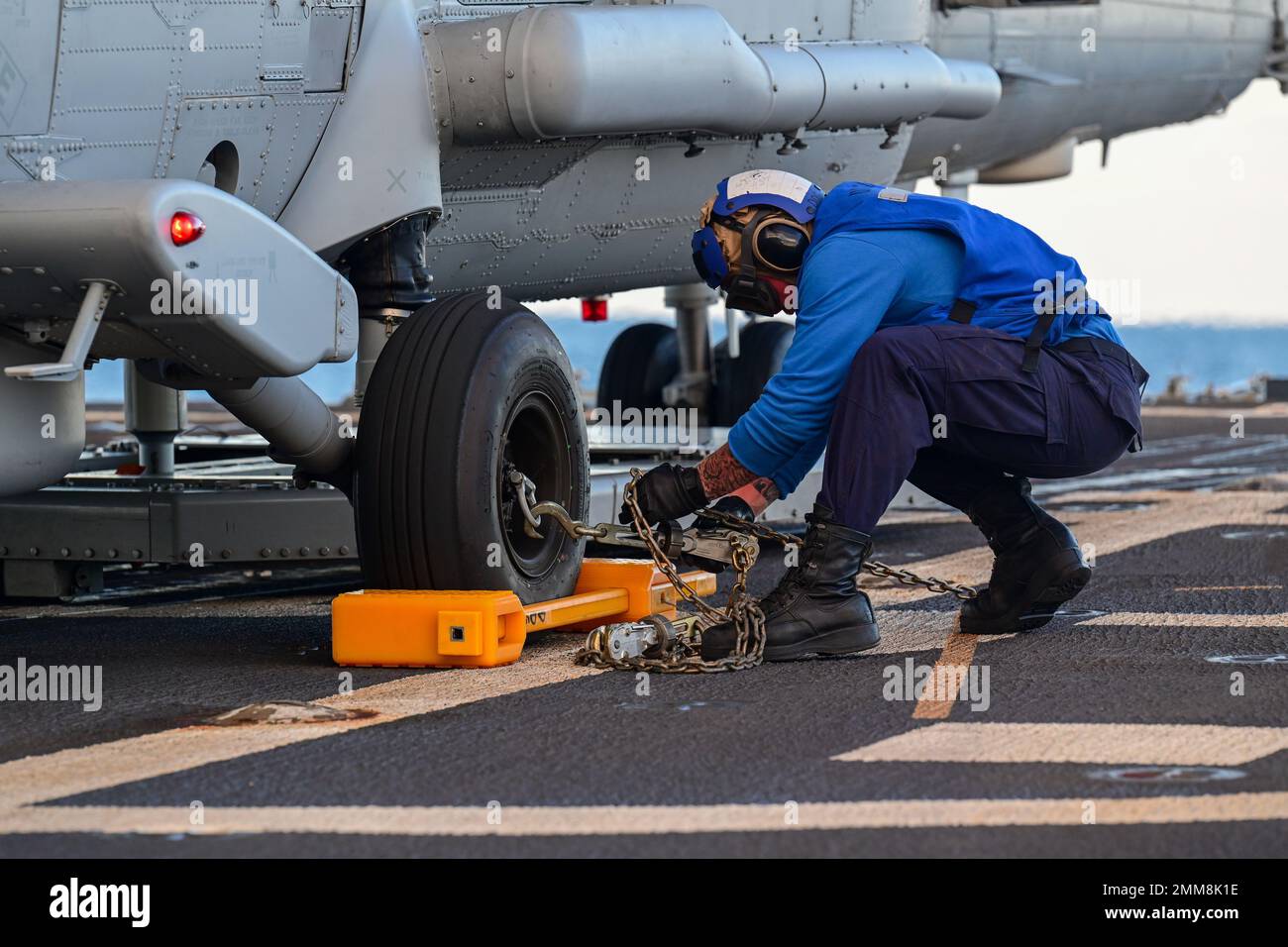 U.S. Navy Seaman Thomas Hughes, assigned to the Arleigh Burke-class ...