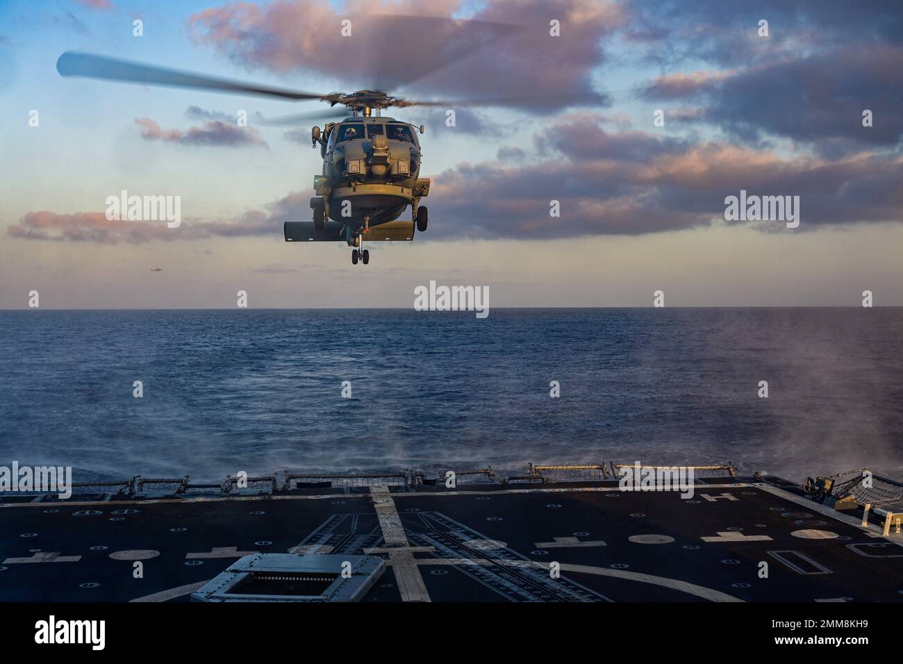 An MH-60R Sea Hawk helicopter attempts to land on the Arleigh Burke ...