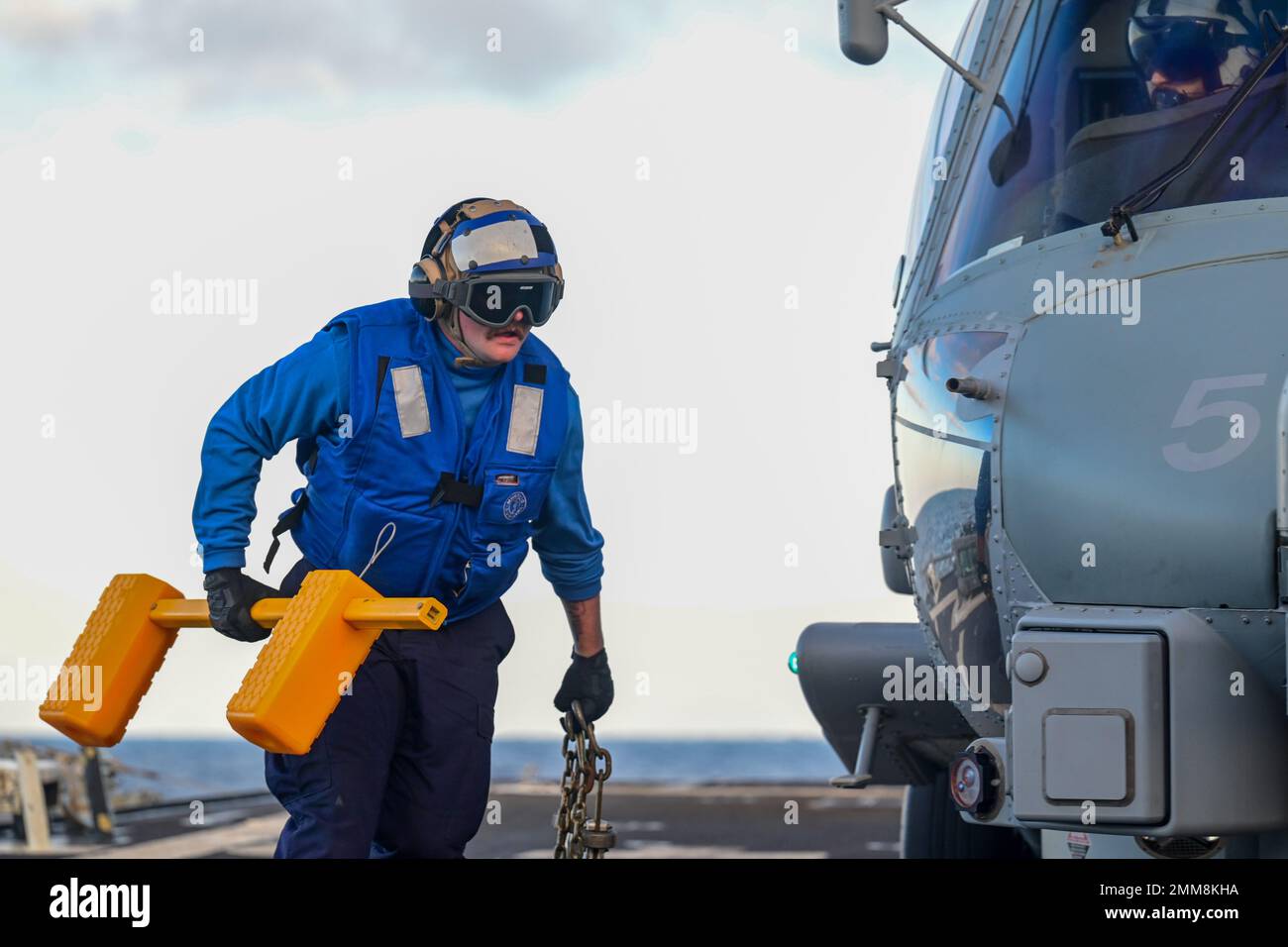 U.S. Navy Seaman Thomas Hughes, assigned to the Arleigh Burke-class ...