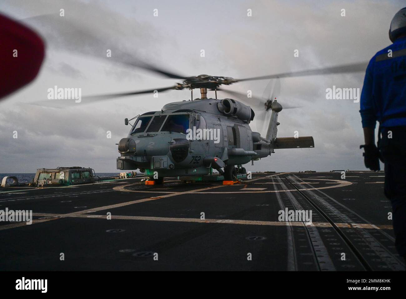 An MH-60R Sea Hawk helicopter prepares to take off from the Arleigh ...
