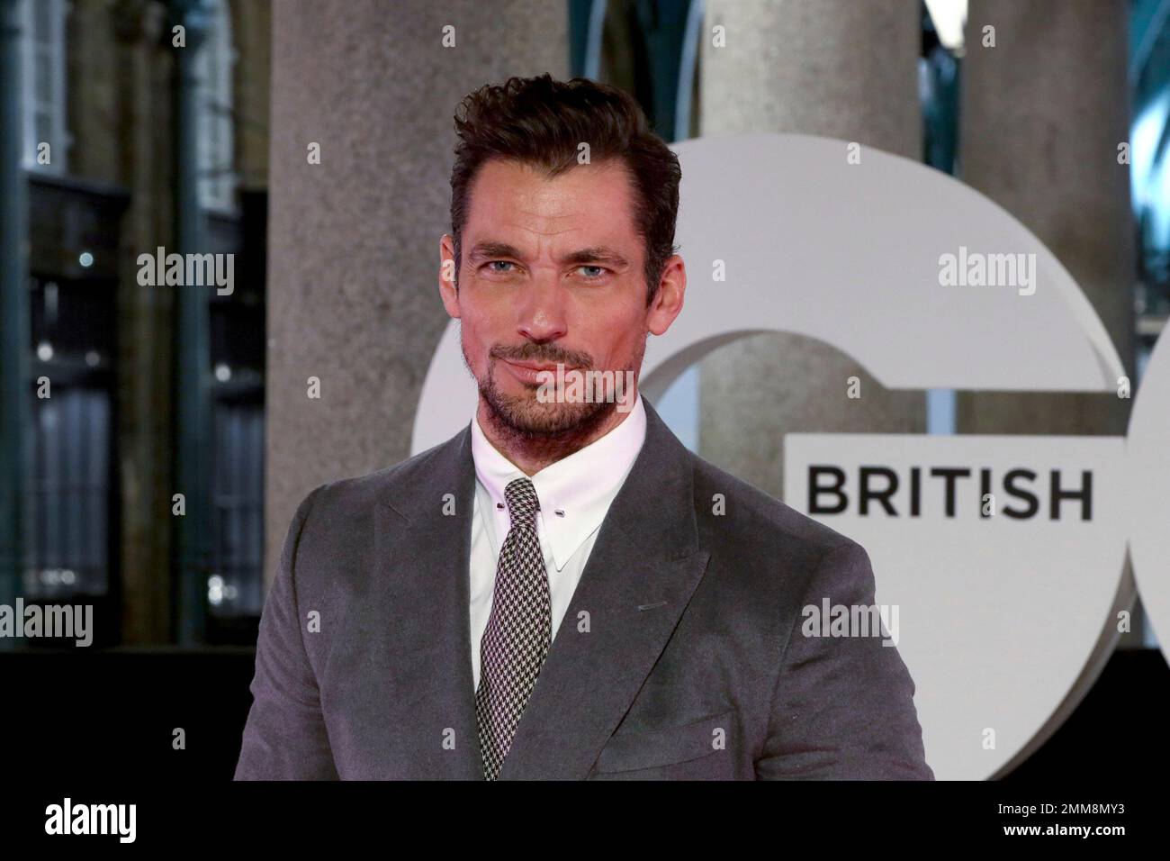 Model David Gandyposes for photographers on arrival at the GQ Magazine ...