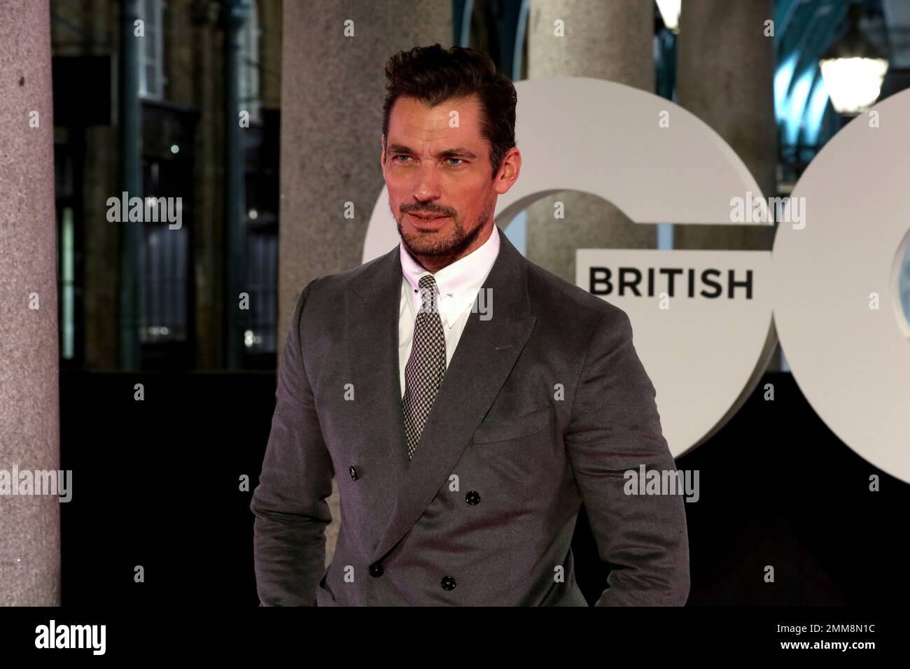 Model David Gandyposes for photographers on arrival at the GQ Magazine ...