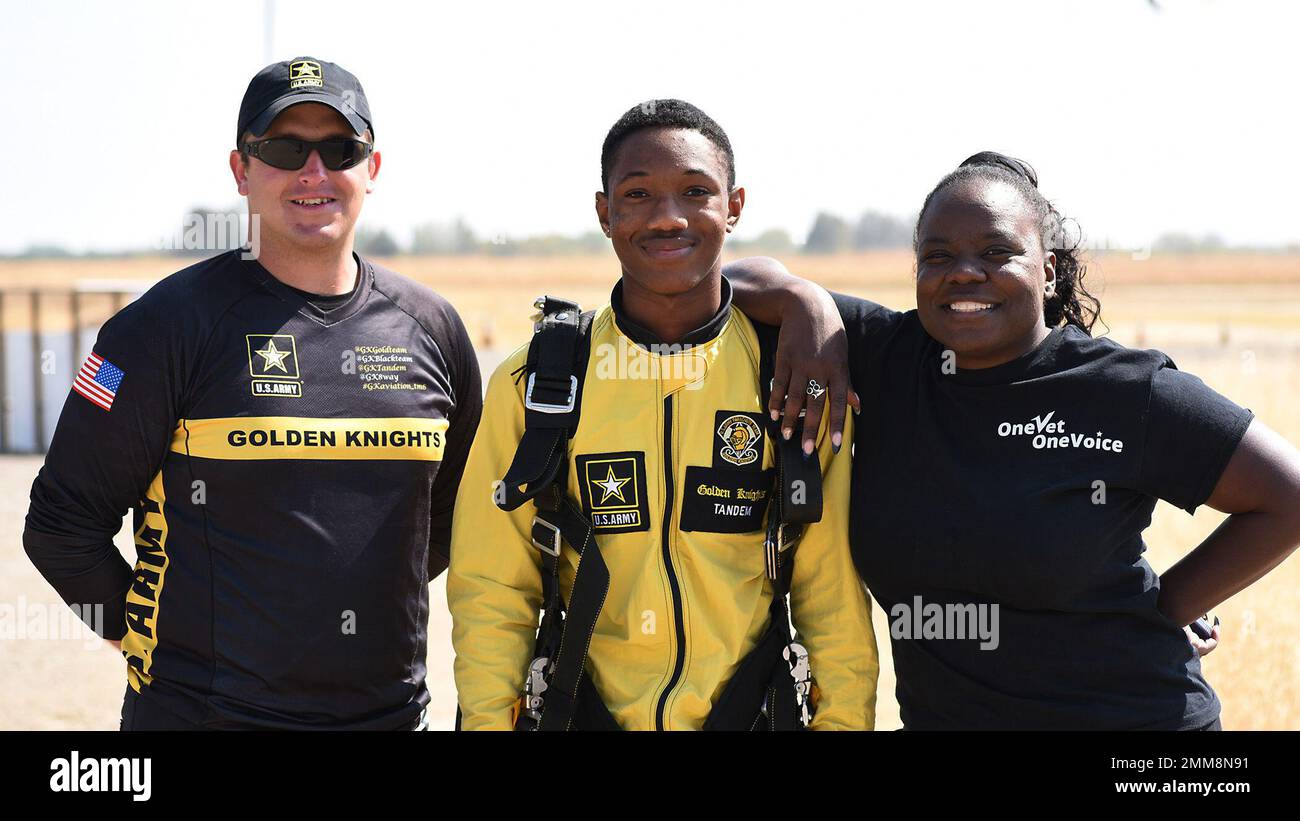 Corbin Johnson (center), tandem camp jumper, poses for a photo with ...