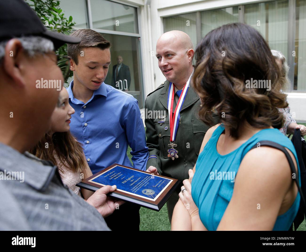 California Highway Patrol Officer Phil Agdeppa shows his family the ...