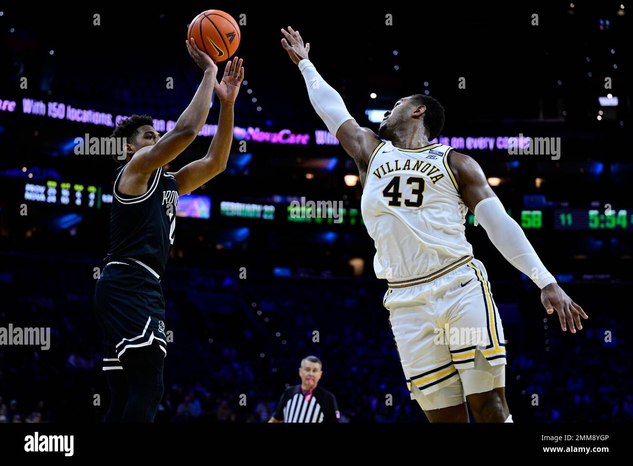 Providence's Noah Locke, left, shoots the ball over Villanova's Eric ...