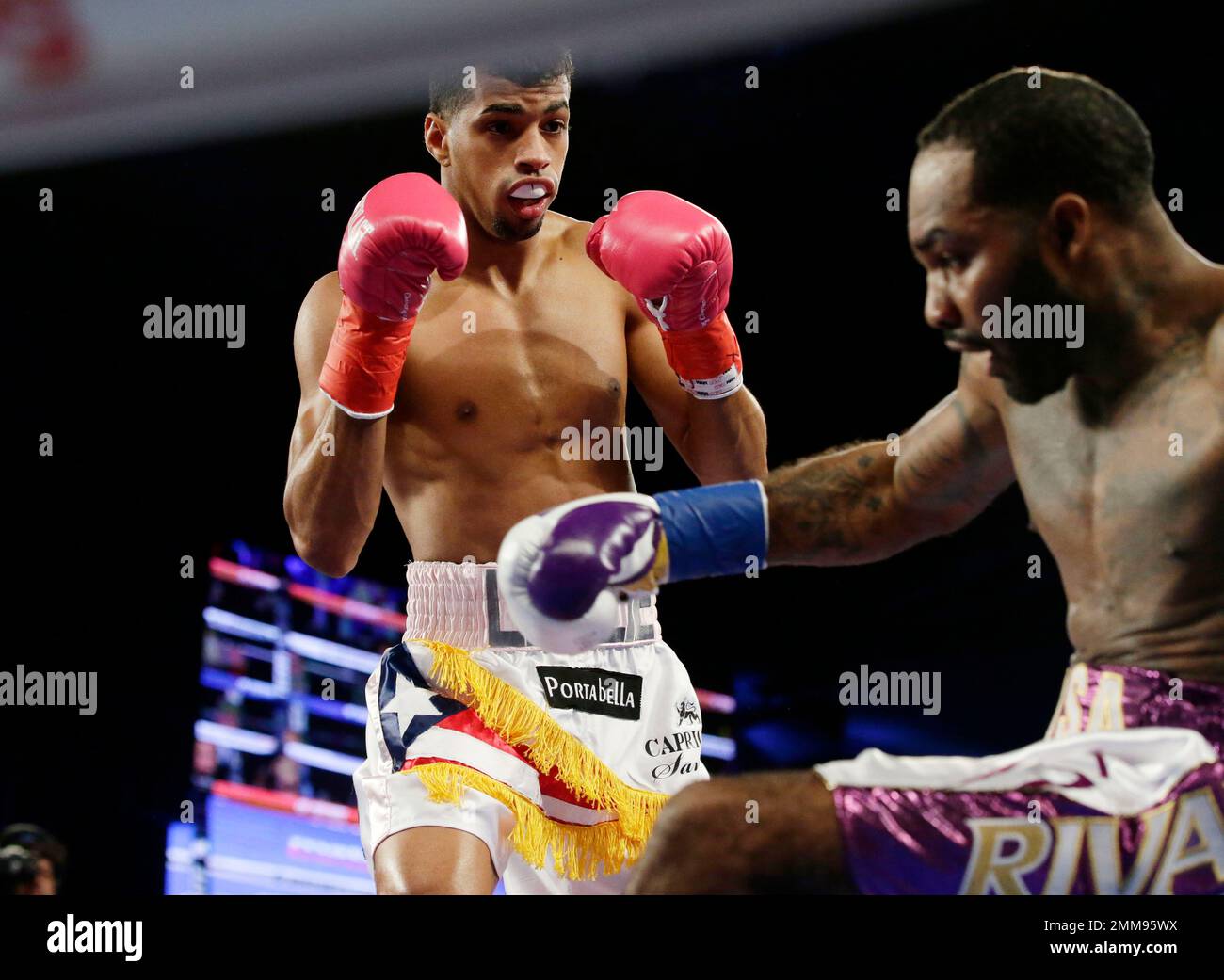 Puerto Rico's Alberto Machado, left, knocks down Yuandale Evans during ...