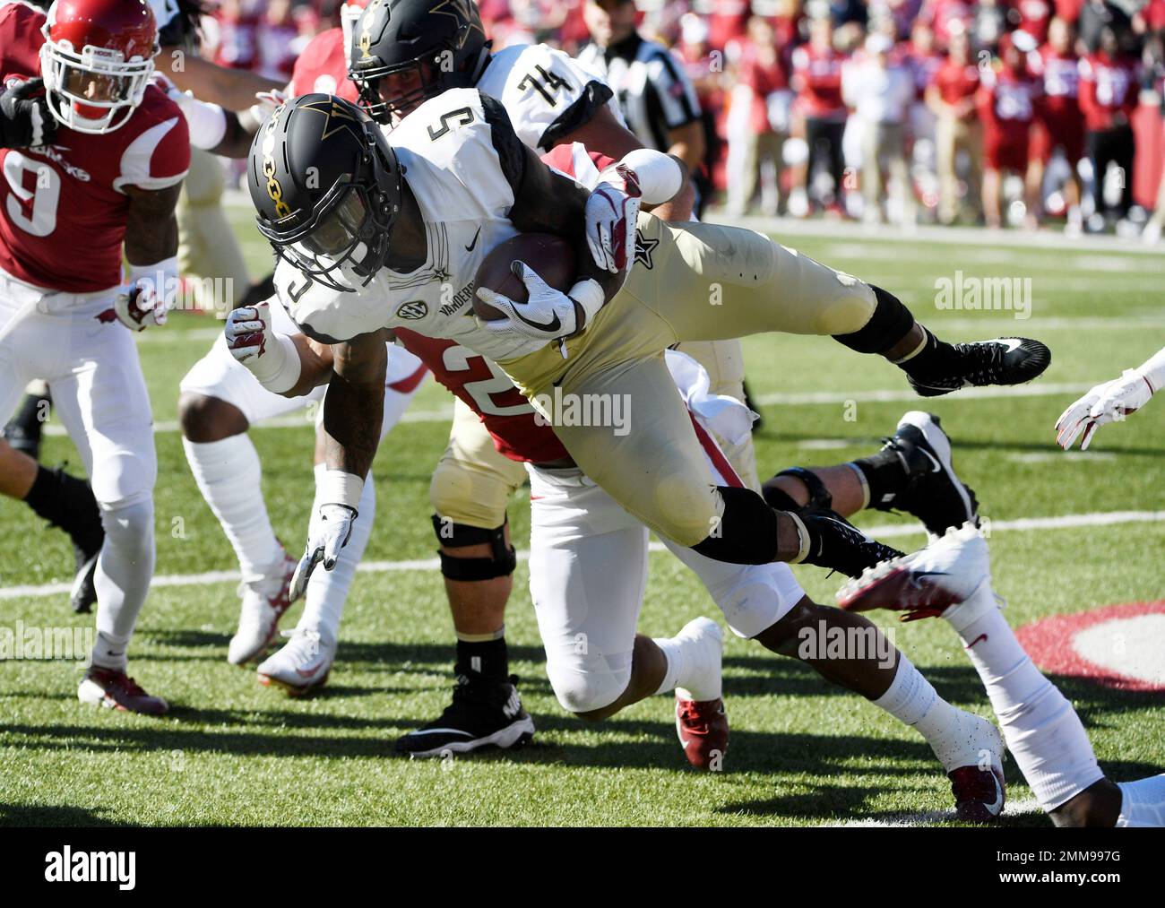 Vanderbilt running back Ke'Shawn Vaughn is tripped up by an Arkansas ...