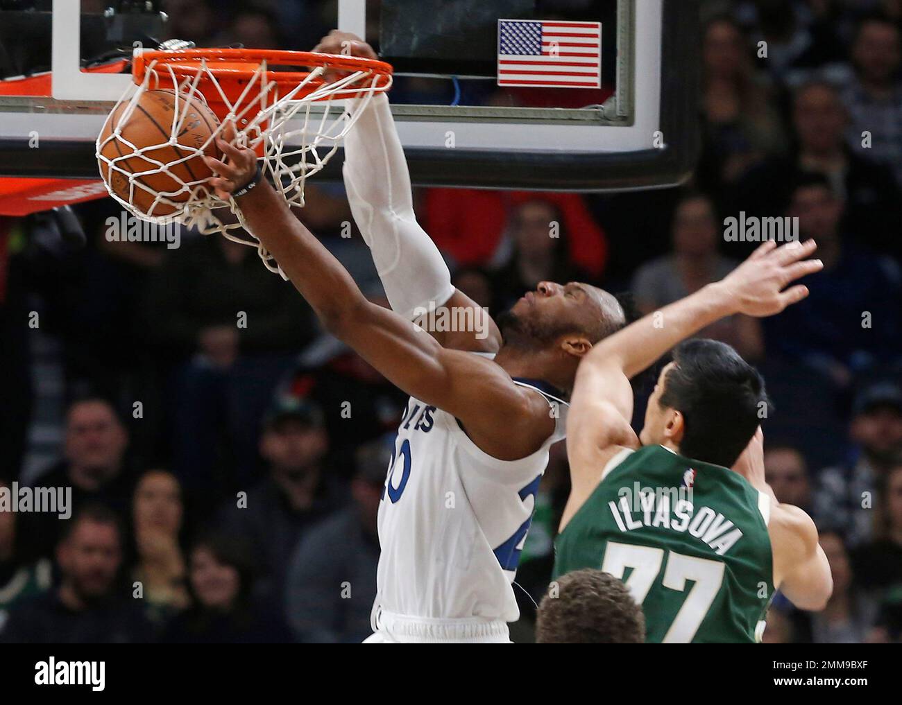 Minnesota Timberwolves' Josh Okogie, left, of Nigeria, dunks as ...