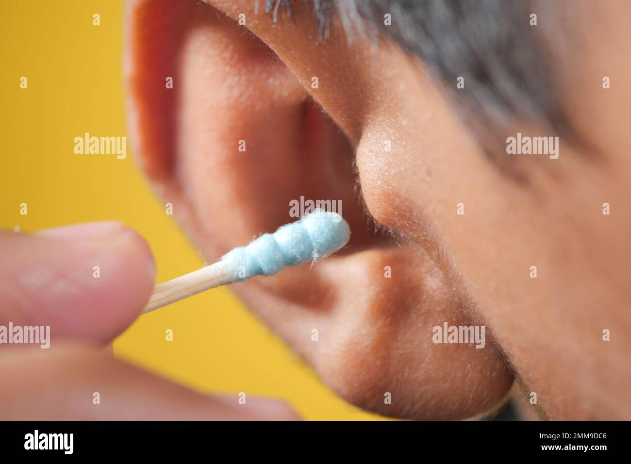 men using ear cotton bar close up Stock Photo - Alamy