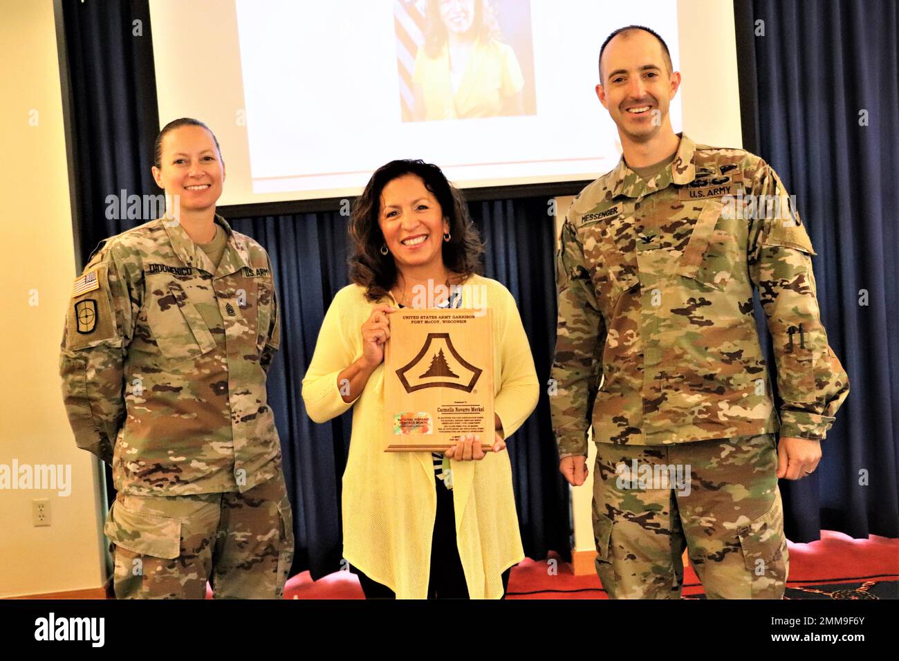Licensed Counselor Carmella Navarro is presented with a special appreciation plaque by Command ...