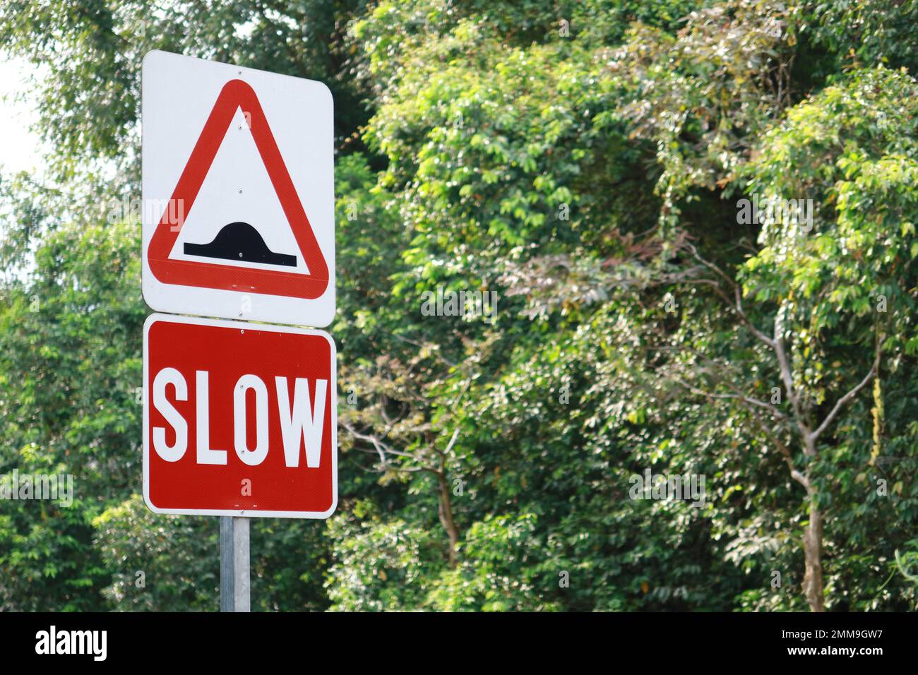 slow sign on street in Singapore Stock Photo - Alamy