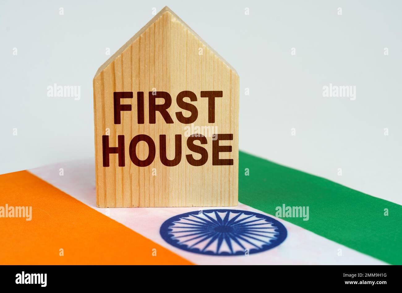 Real estate concept. On the flag of India there is a model of a wooden ...