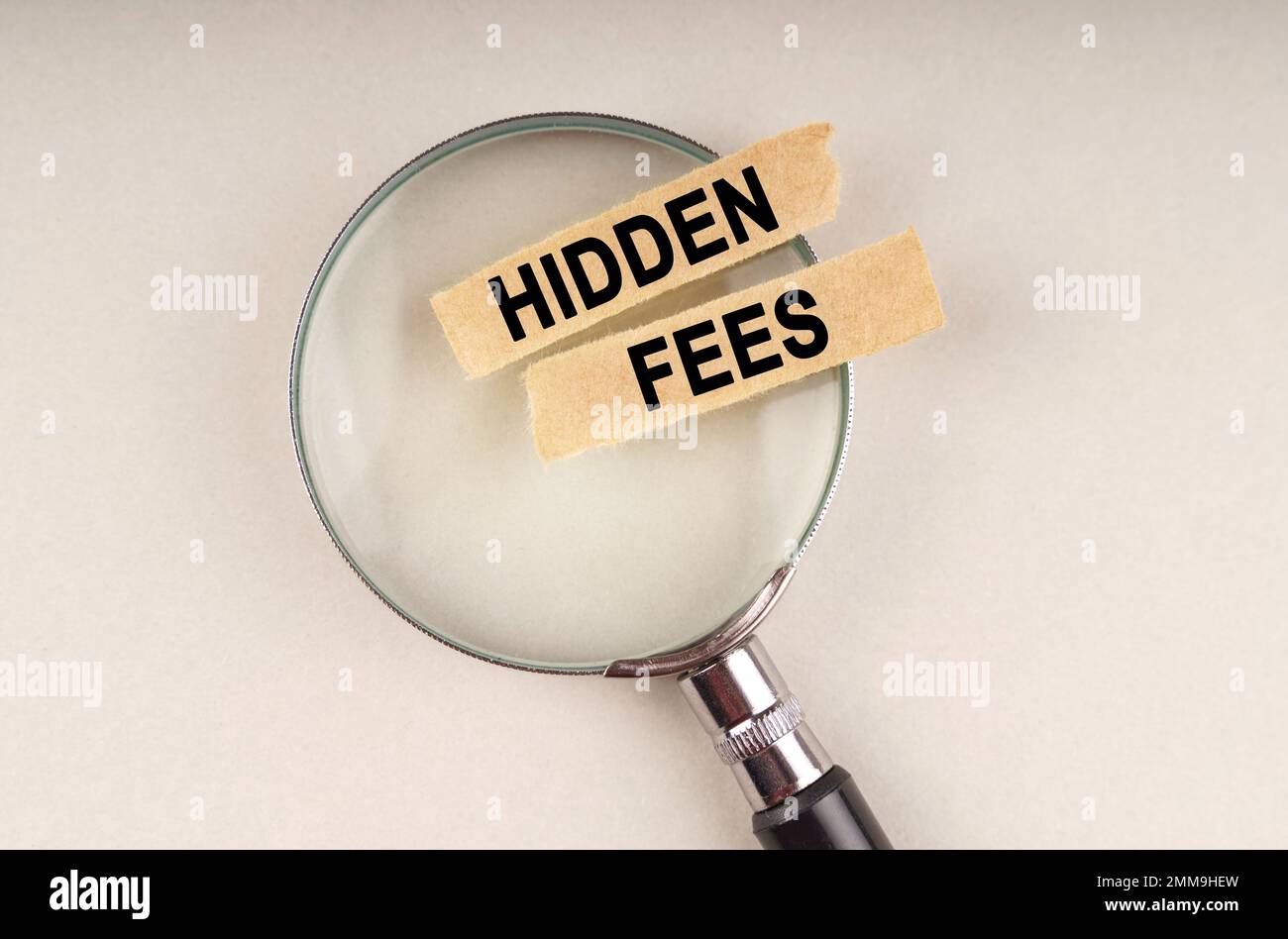 On the magnifying glass are paper strips with the inscription - Hidden ...