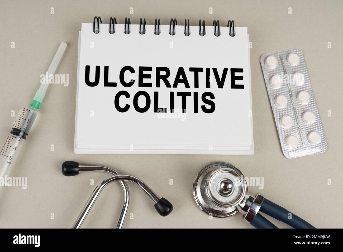 Medical concept. On a gray surface, a syringe, a thermometer, a ...