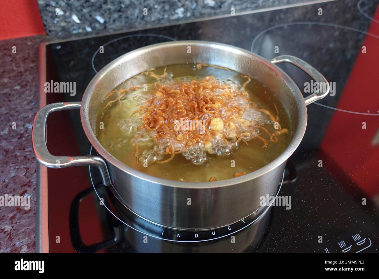 Swabian cuisine, preparation Striebele, frying dough in hot fat, fat ...