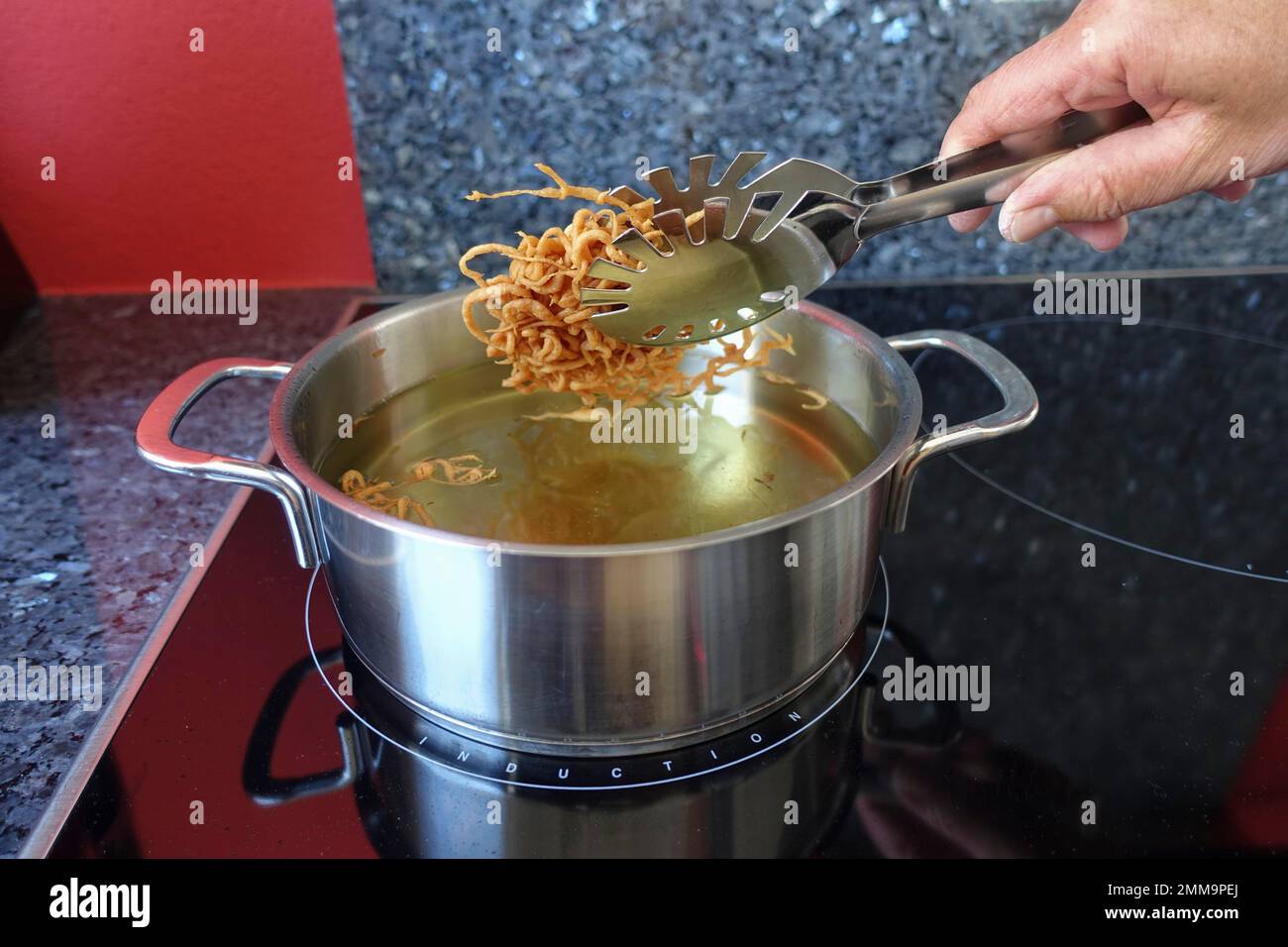 Swabian cuisine, preparation Striebele, frying dough in hot fat, fat ...
