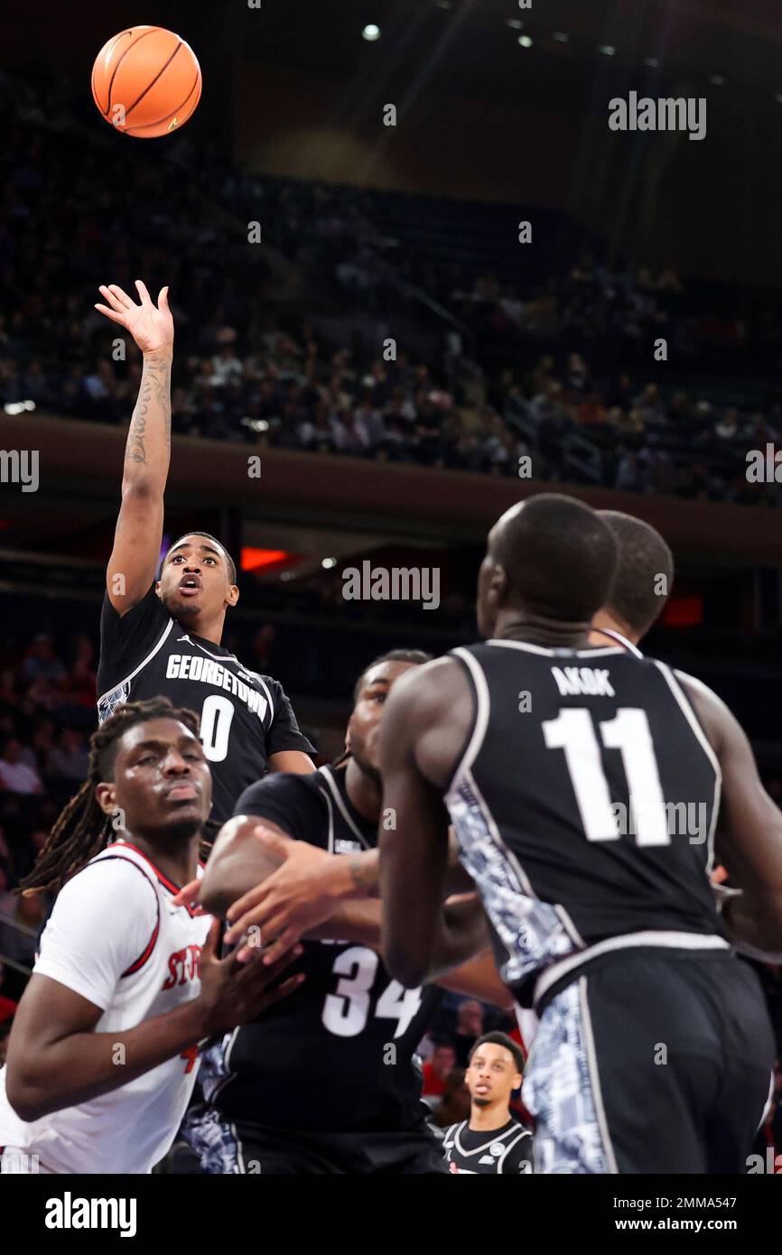 Georgetown guard Brandon Murray (0) shoots against St. John's forward O ...