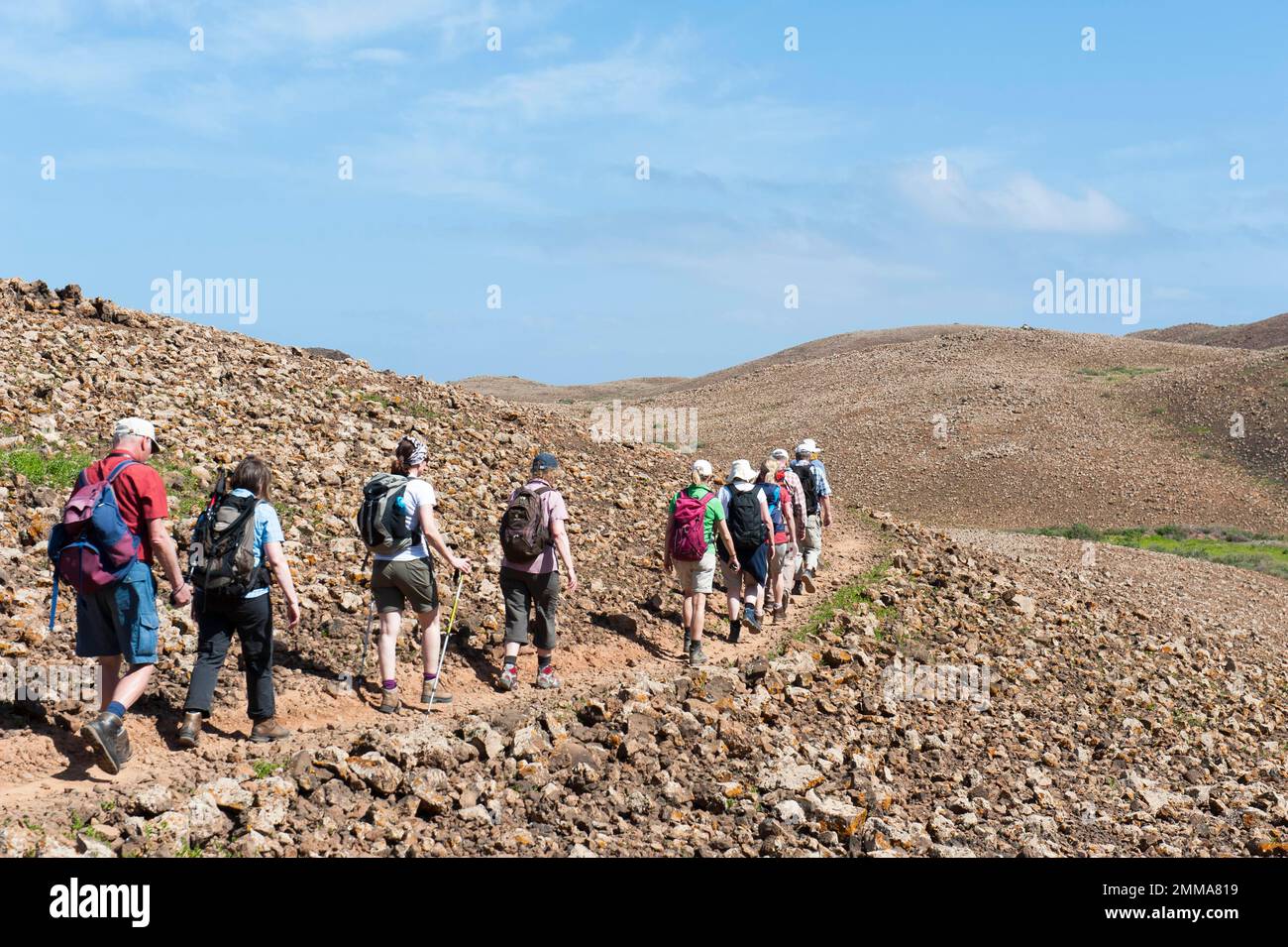 Hiking group, barren landscape, hikers walking one behind the other on ...