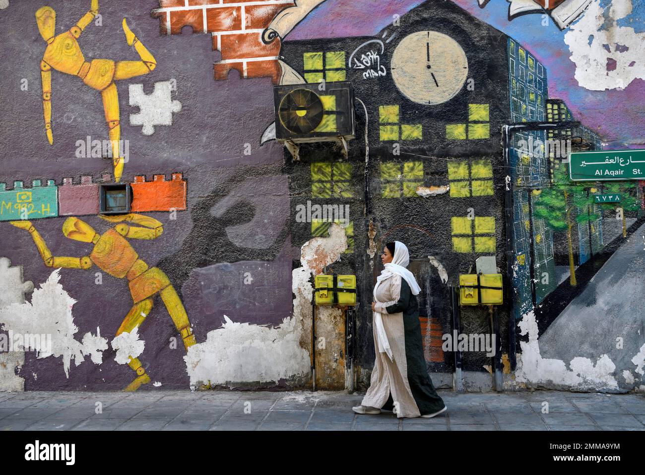 Veiled woman in front of mural, graffito, Al Khobar, ash-Sharqiyya ...