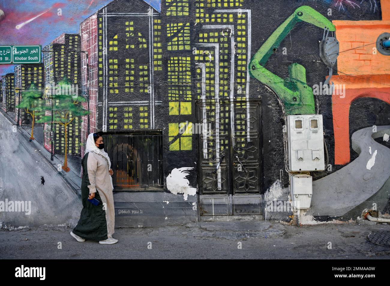 Veiled woman in front of mural, graffito, Al Khobar, ash-Sharqiyya ...