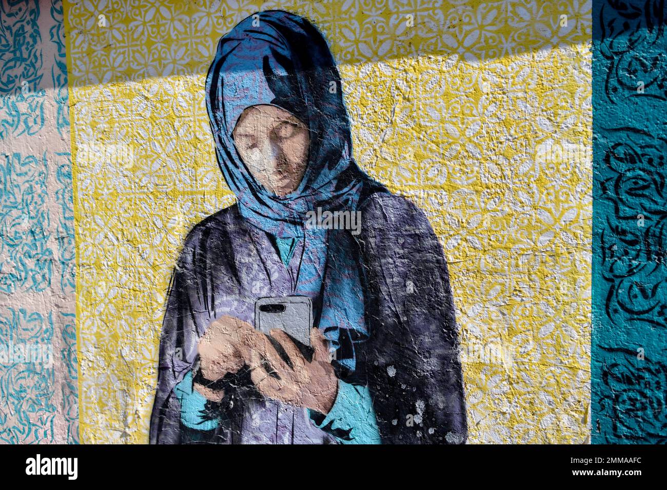Mural of a veiled woman with a mobile phone, graffito, Al Khobar, ash ...