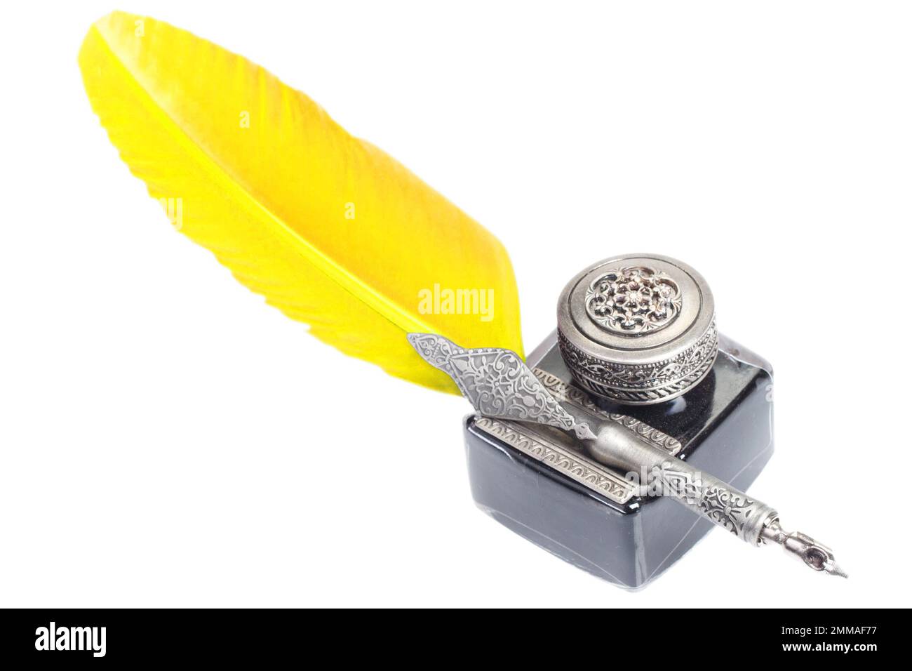 Old vintage yellow feather fountain pen with inkwell on white ...