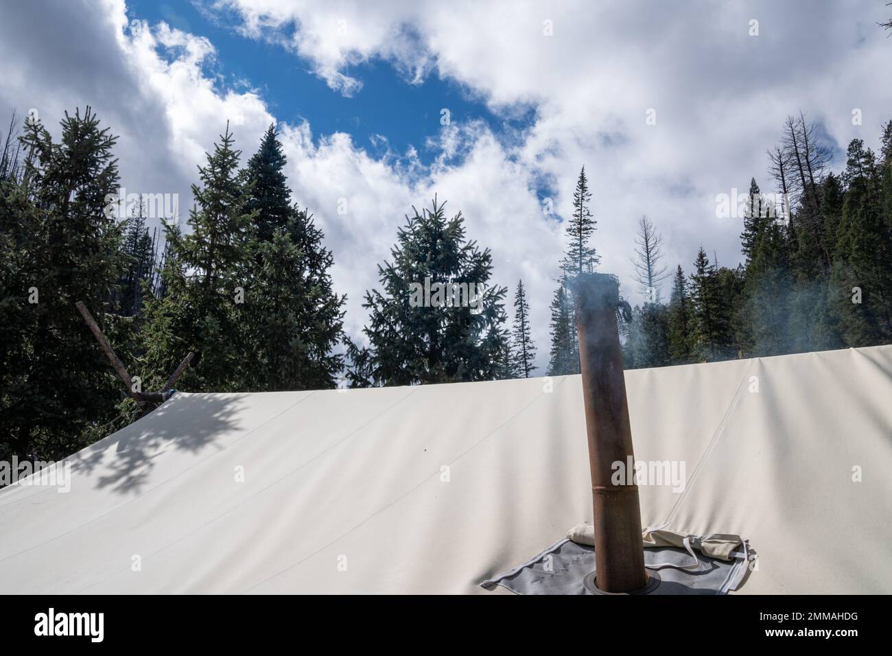 Smoke rises from a chimney on a tent for ventilation from the camp ...