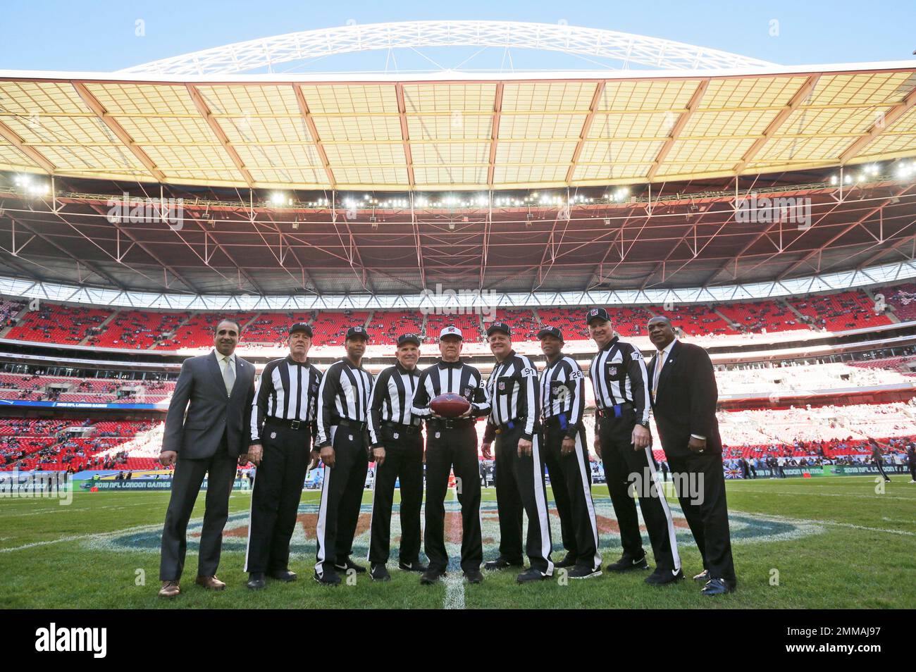 The officiating crew pose for a photo before the NFL football game ...