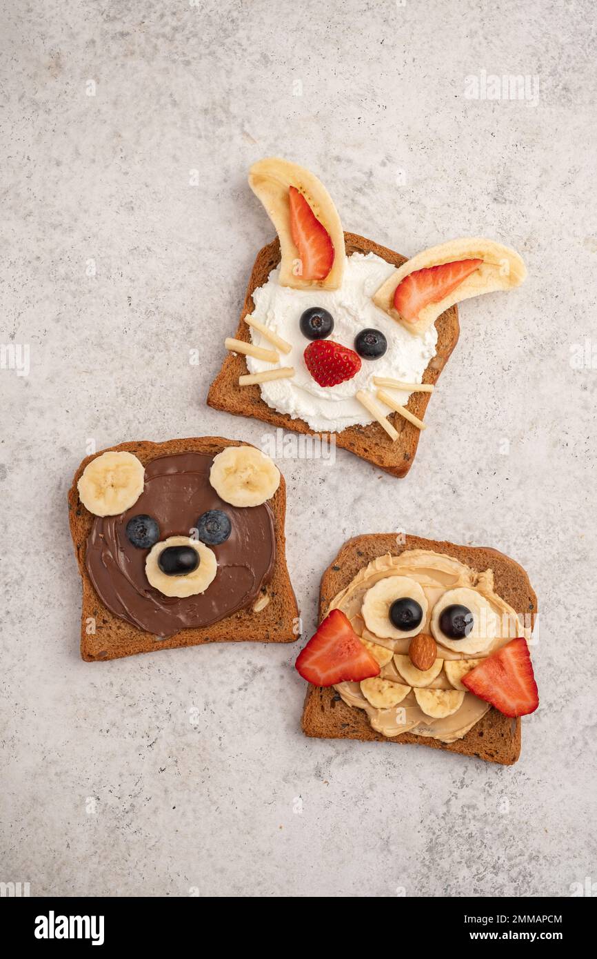 Funny animal faces toasts for kids lunch Stock Photo - Alamy