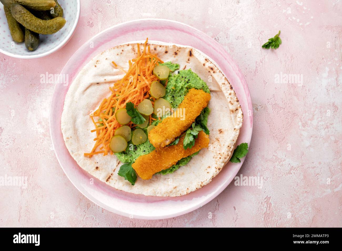 Fish fingers wraps with pea puree Stock Photo - Alamy