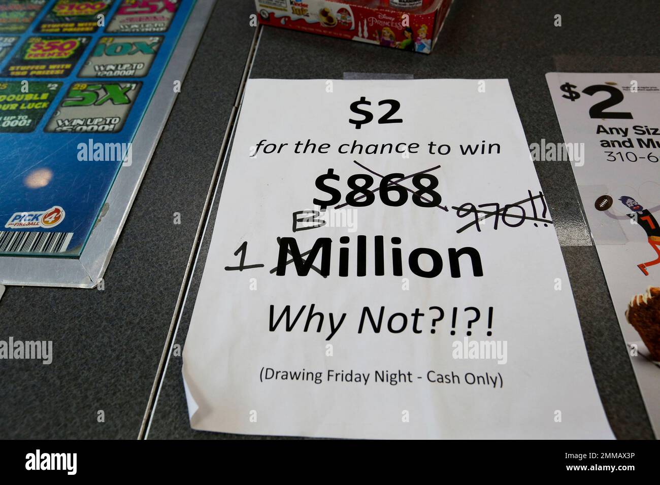 An updated paper sign is displayed the counter of a 7-Eleven store ...