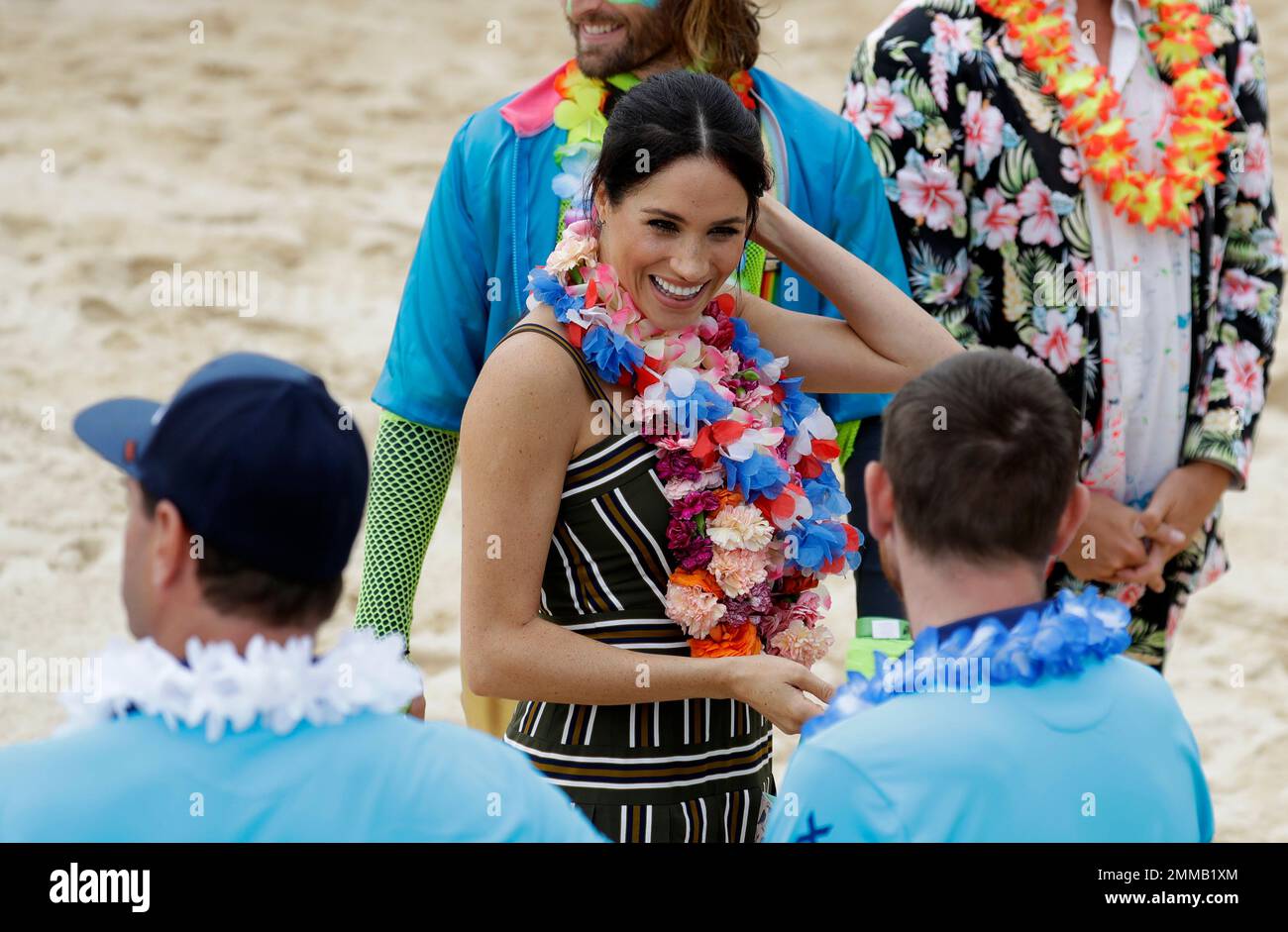 Britain's Prince Harry and Meghan, Duchess of Sussex talk with a ...