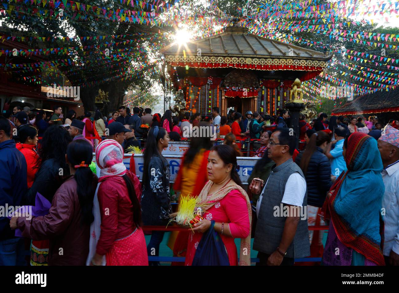 Hindu devotees stand in a queue to offer prayers on the ninth day of ...