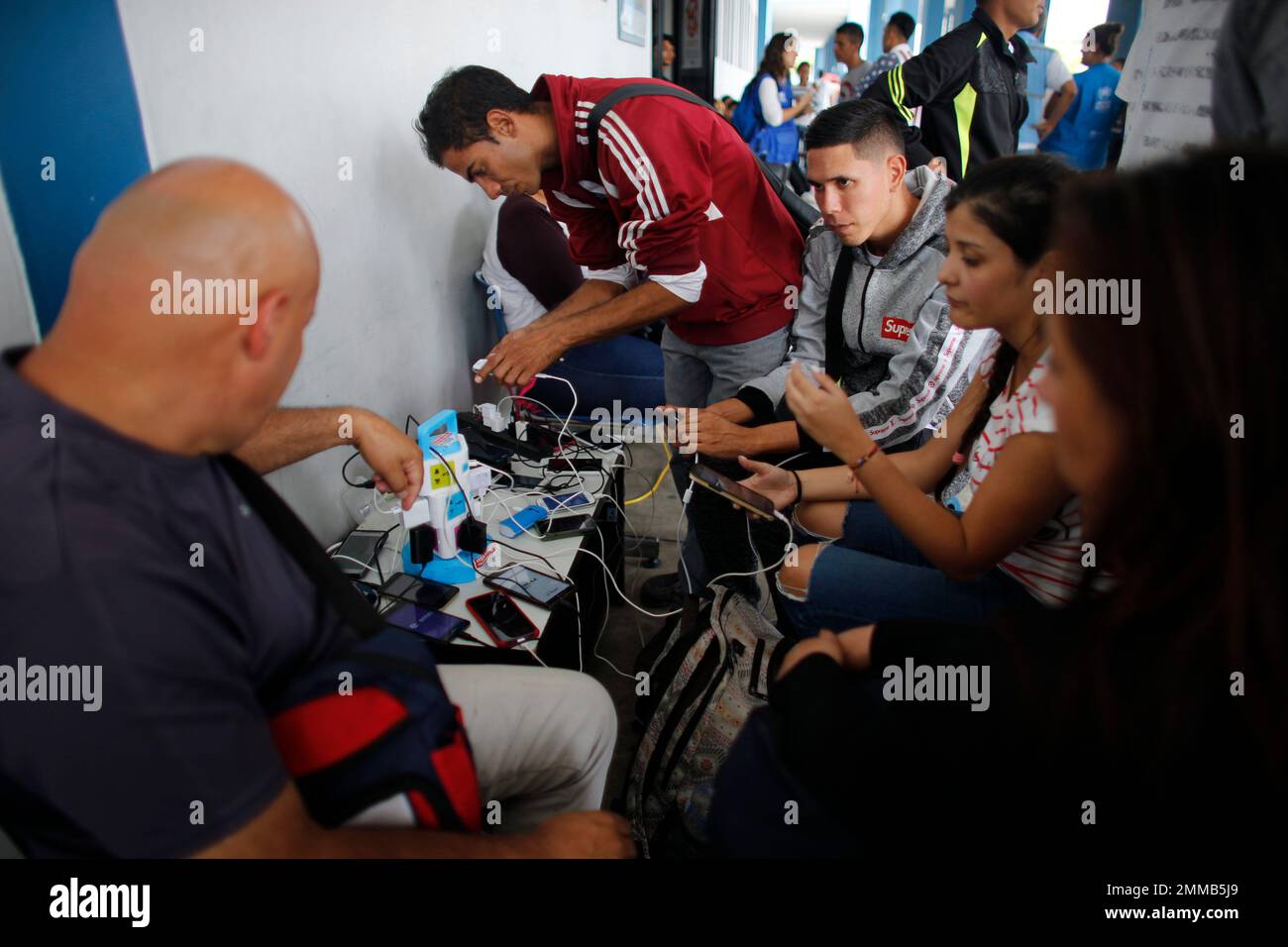 In this photo Sept. 7, 2018 photo, Venezuelan migrants charge their ...
