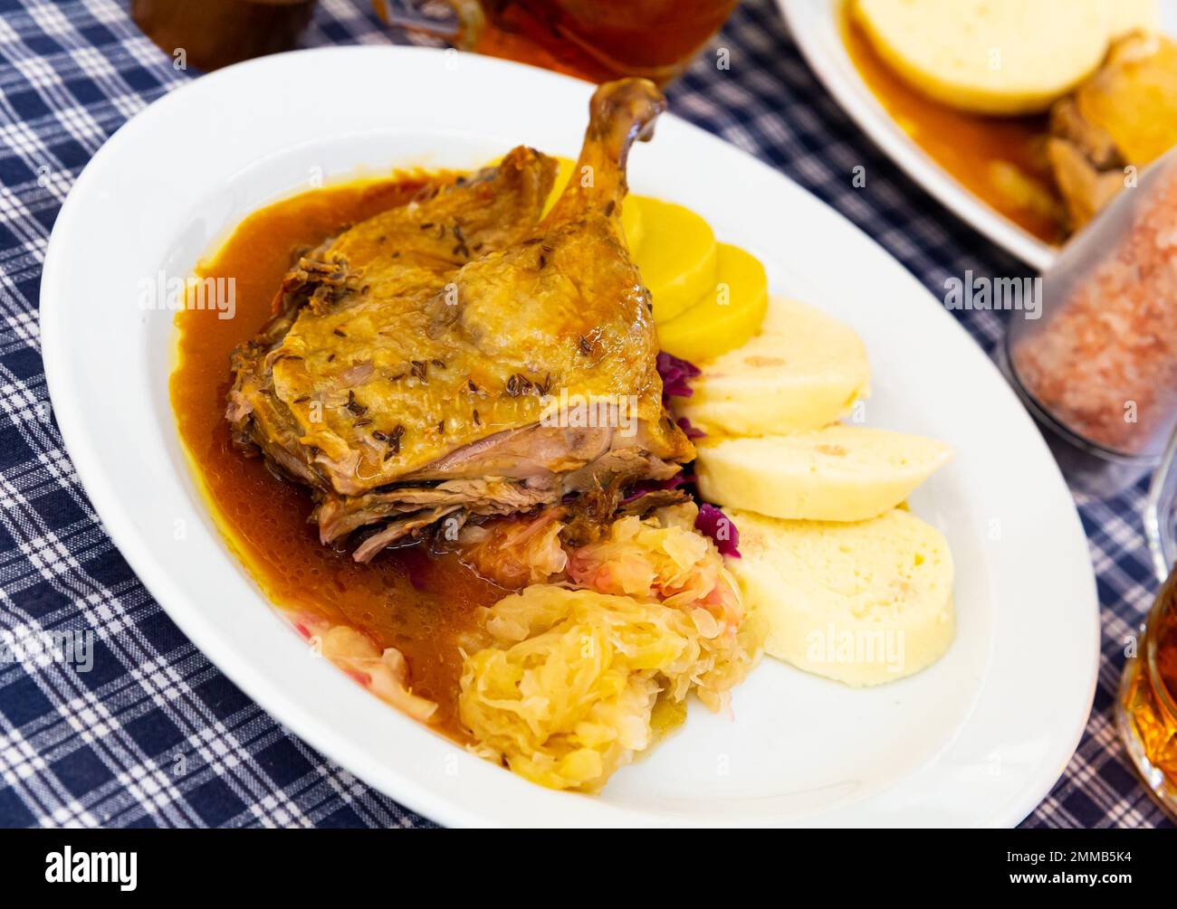 Grilled duck leg quarter with red and white cabbage Stock Photo - Alamy